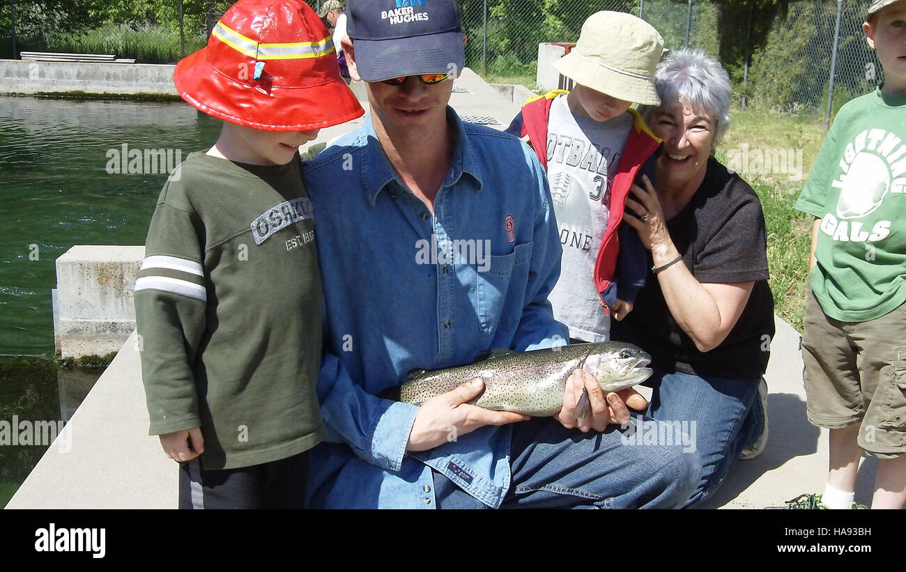 A family proudly displays their catch after a day of fishing at a ...
