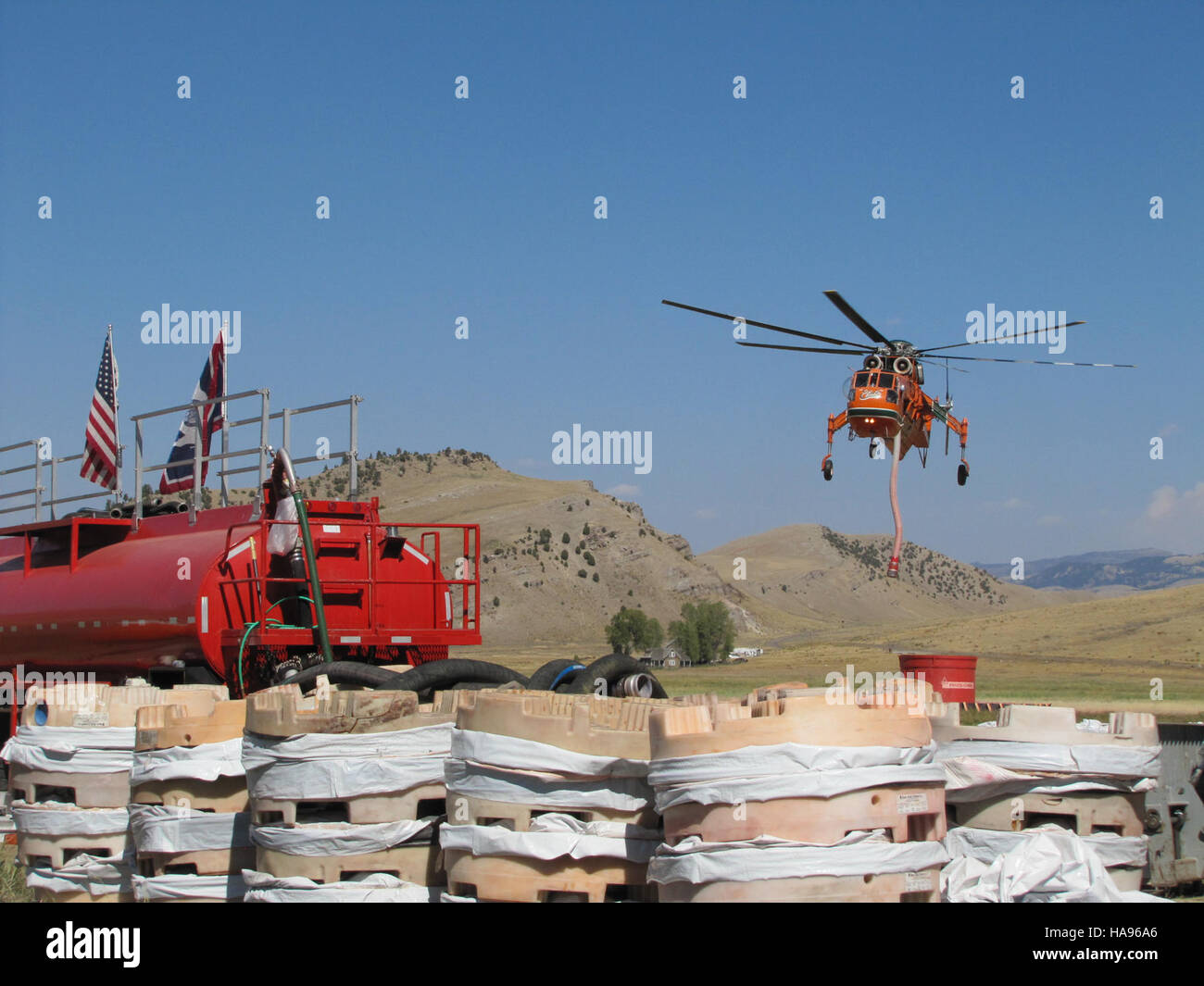 This image shows a fire retardant mixing plant and helicopter operation ...