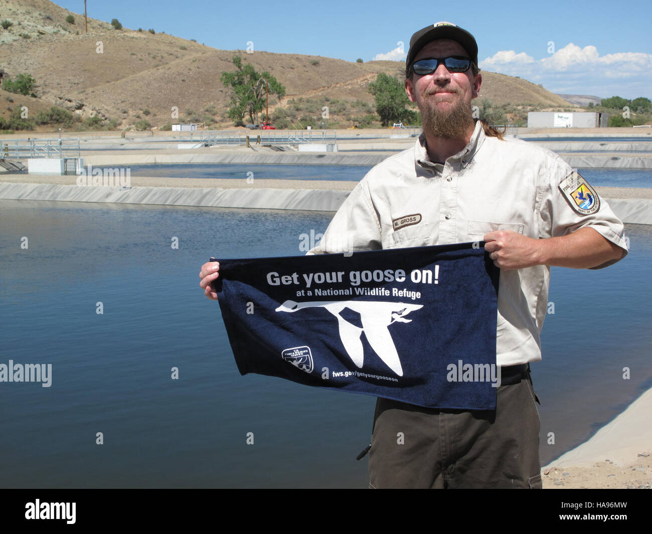 A fish biologist works in grow-out ponds in national parks to ensure ...