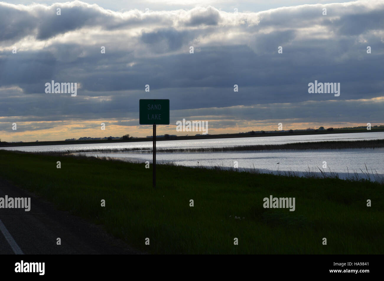 The 'Sand Lake' sign, captured at dusk in the Mountain Prairie region ...