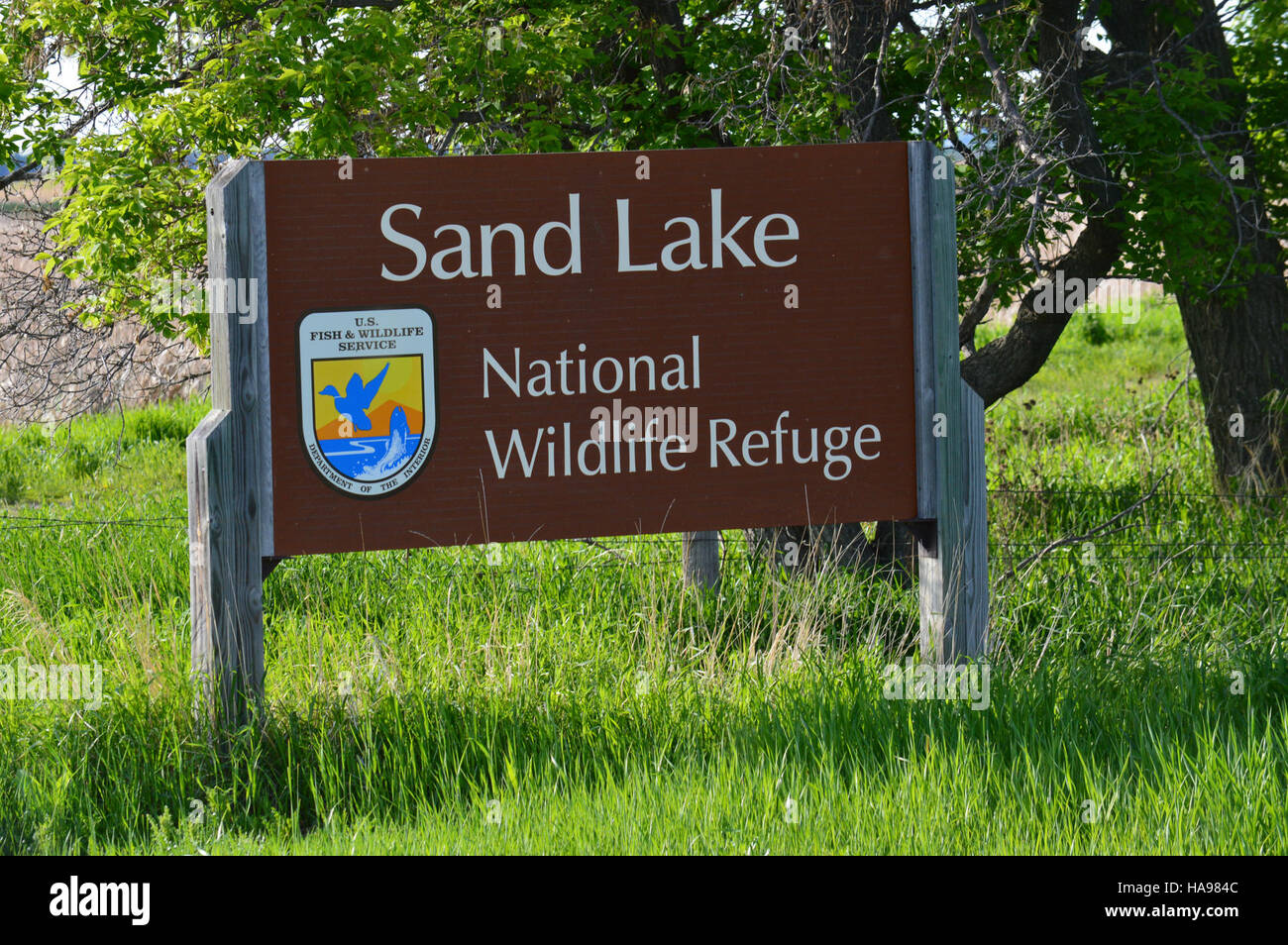 This image shows a sign for Sand Lake National Wildlife Refuge ...