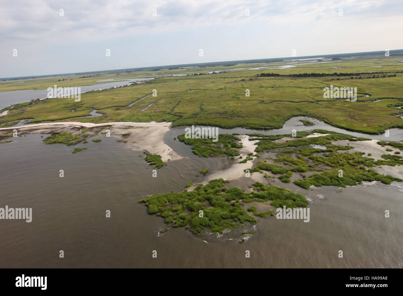 The eroded shoreline at Gandy's Beach in a national park illustrates ...