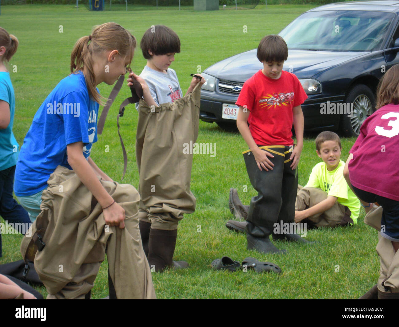 A wildlife biologist prepares for fieldwork in a national park, donning ...