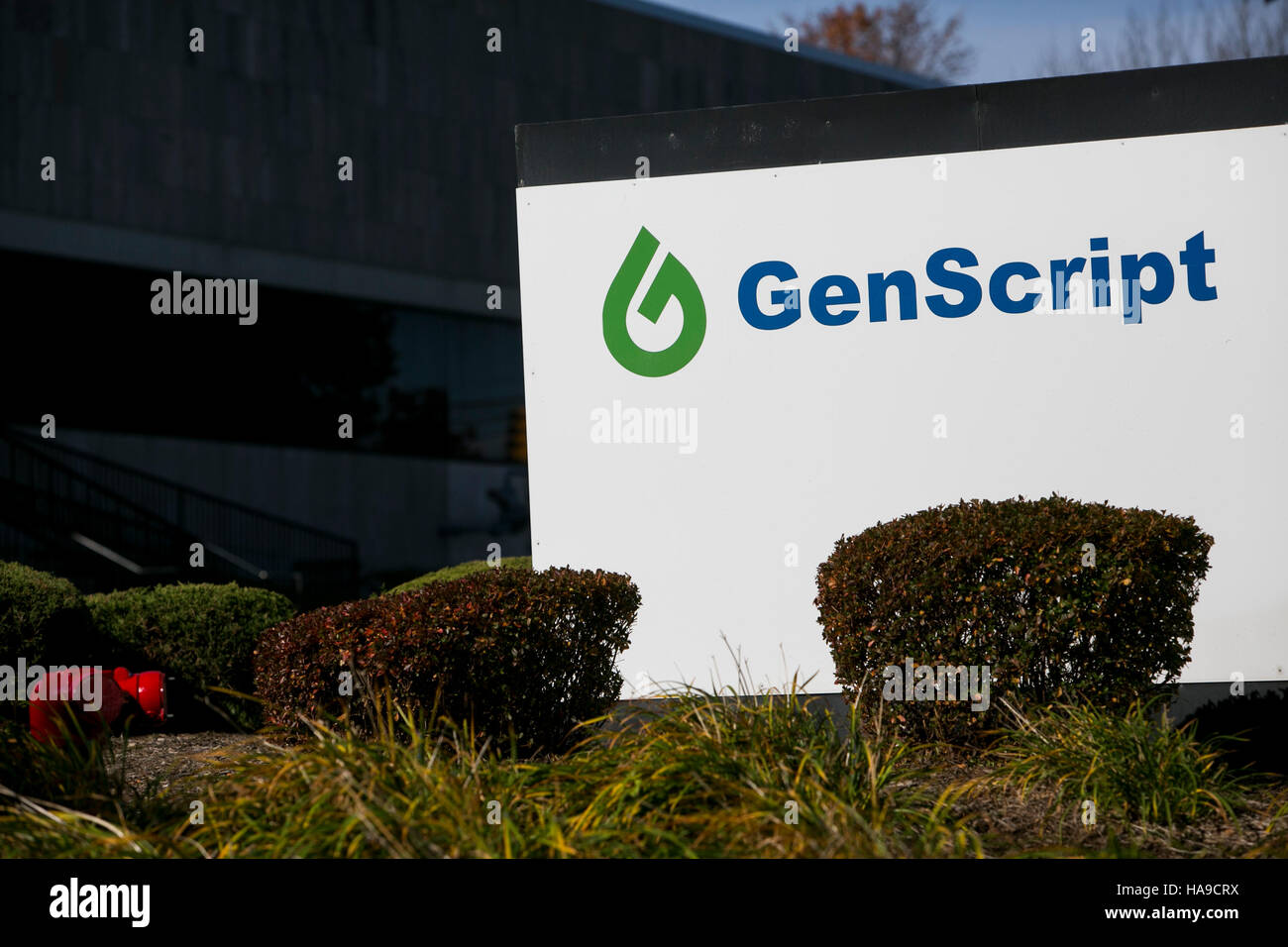 A logo sign outside of a facility occupied by GenScript in Piscataway ...
