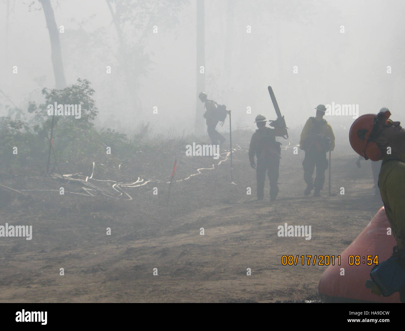 Sawyers work in dense smoke in the Northeast, helping to mitigate the ...