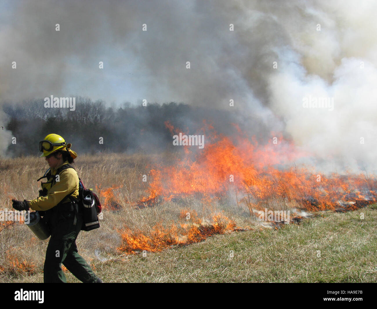 This image shows a firefighter from The Nature Conservancy (TNC ...