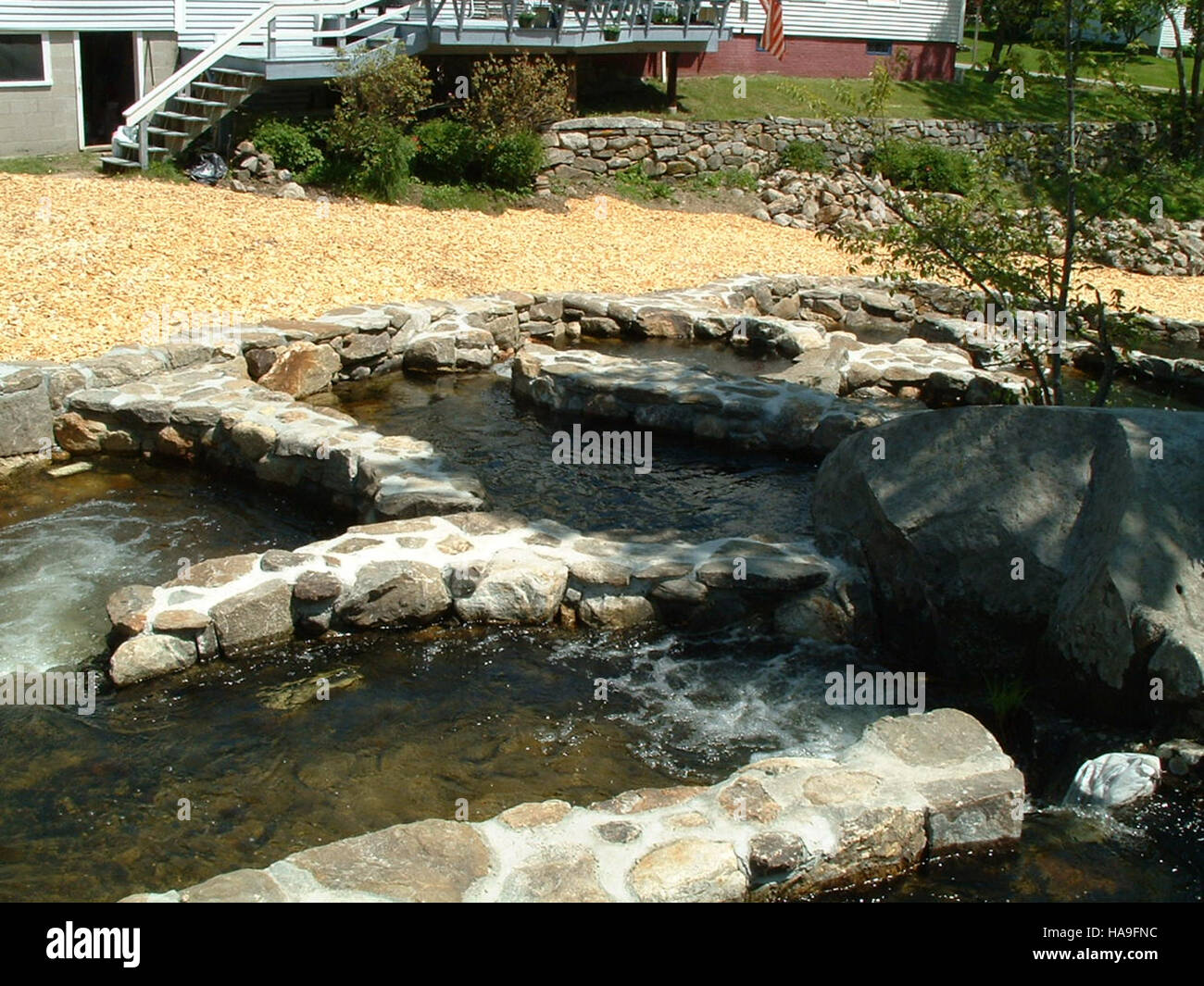 A pool and weir ladder, part of a fish passage system, is installed in ...