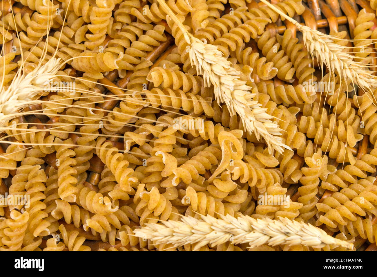 pile of spiral shaped raw pasta with wheat Stock Photo - Alamy