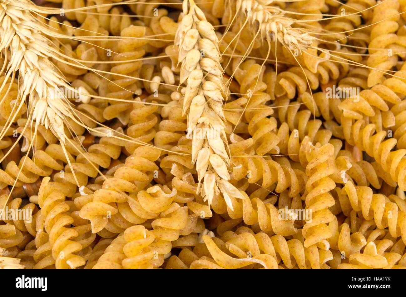 closeup of spiral shaped raw pasta with wheat Stock Photo - Alamy