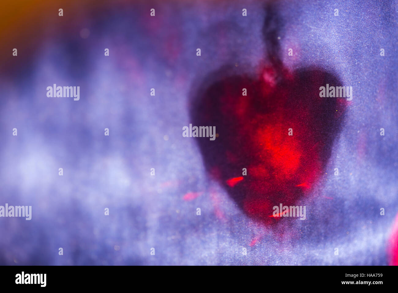 Red heart shape shadow on blue surface, abstract holiday background ...