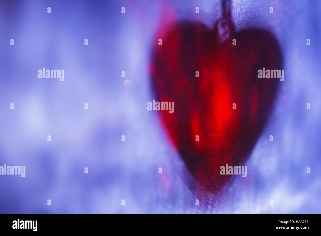 Red heart shape shadow on blue surface, abstract holiday background ...