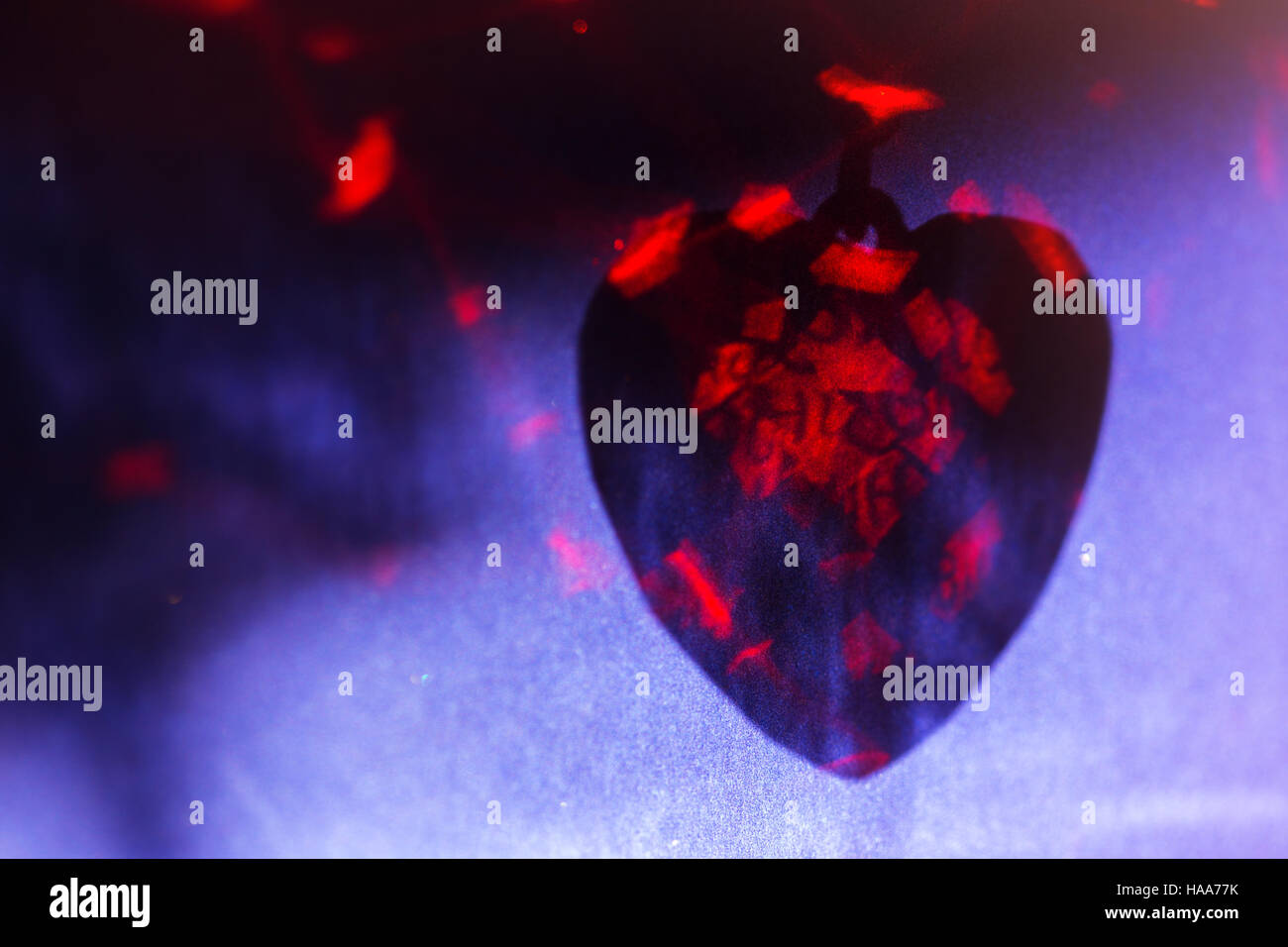 Red heart shape shadow on blue surface, abstract holiday background ...