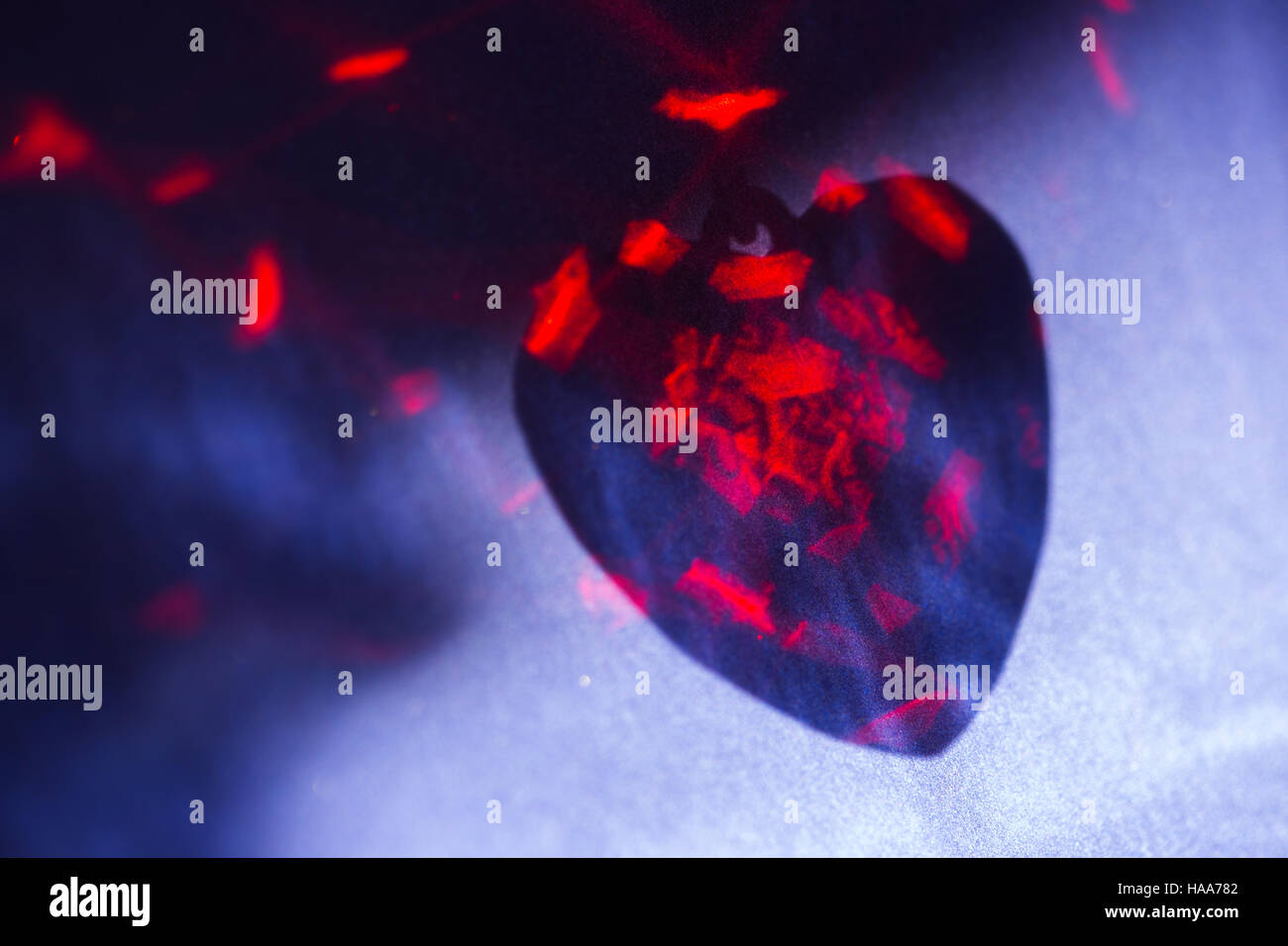 Red heart shape shadow on blue surface, abstract holiday background ...