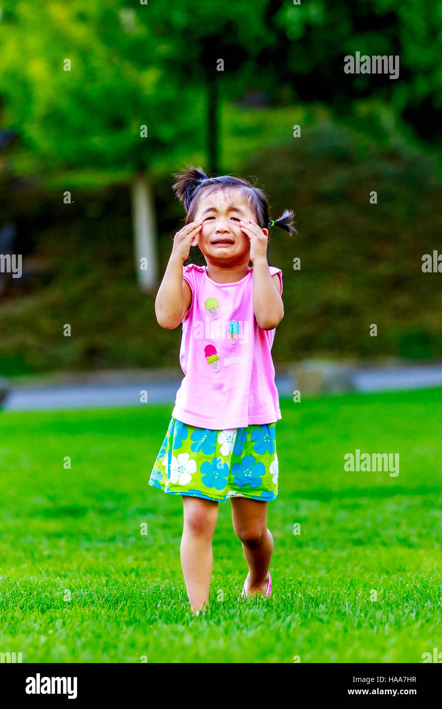 Adorable girl upset and cry in the park Stock Photo - Alamy