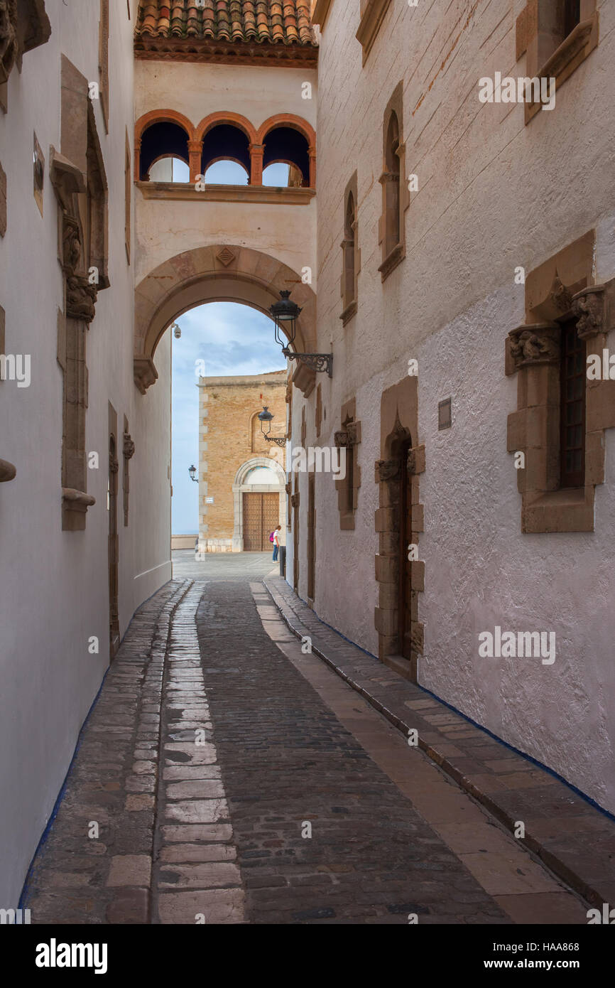 Sitges Old Town in Catalonia, Spain, narrow street with arched covered ...
