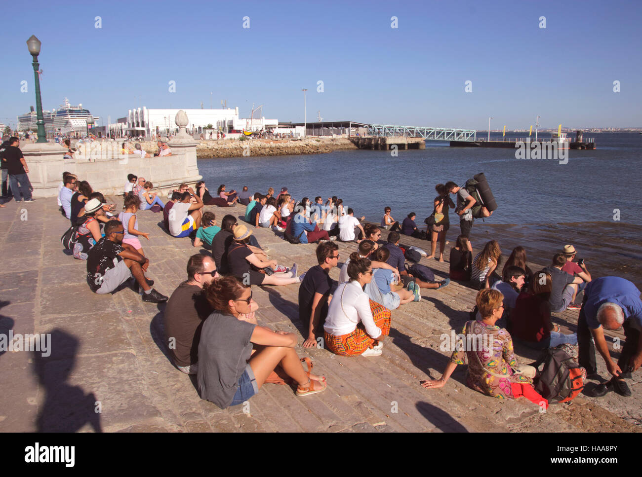 People relaxing at Cais Das Colunas near Praca do Comercio by River ...
