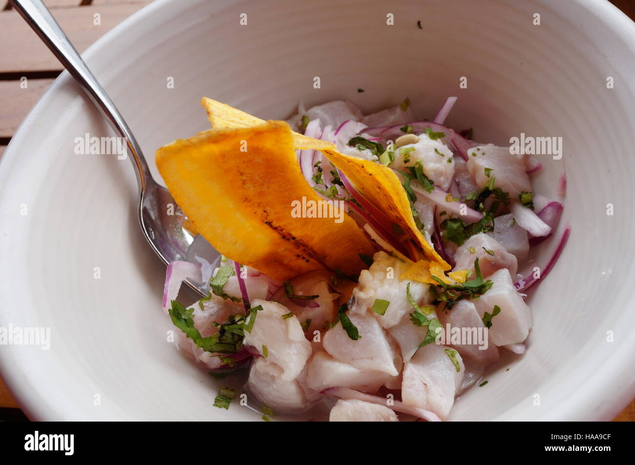 Raw fish ceviche with plantain chips Stock Photo - Alamy