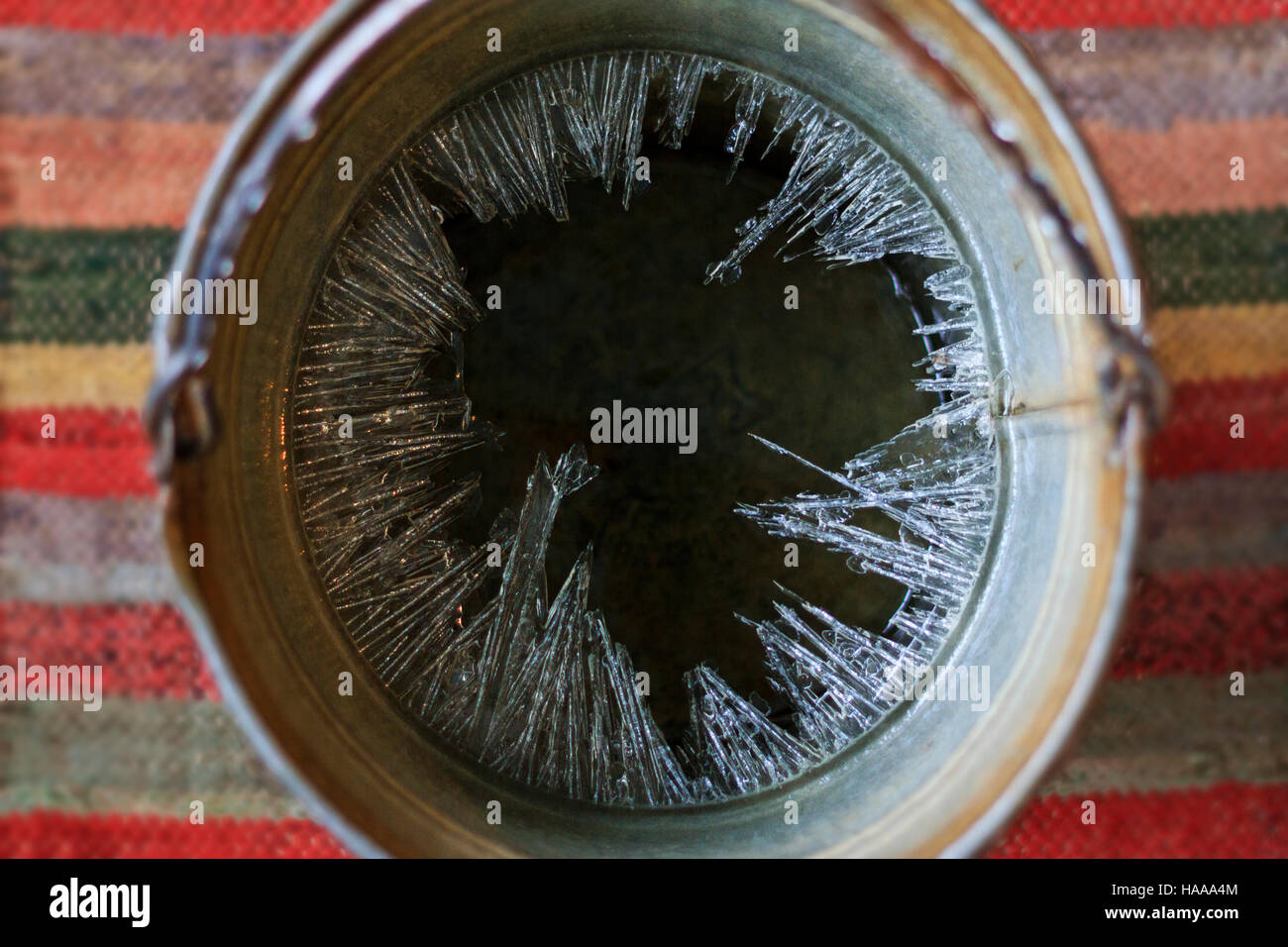 Metal bucket of frozen water in the middle Stock Photo - Alamy