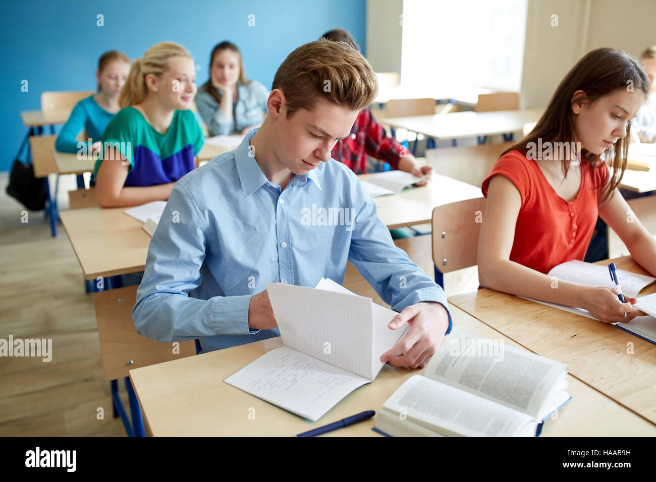 group of students with books at school lesson Stock Photo - Alamy