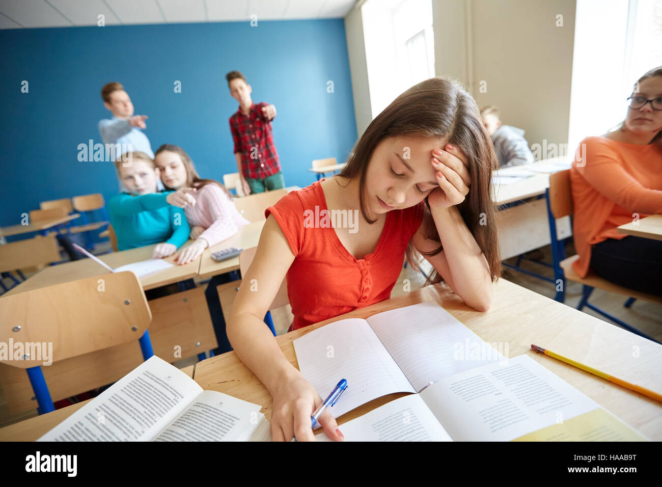 students gossiping behind classmate back at school Stock Photo - Alamy