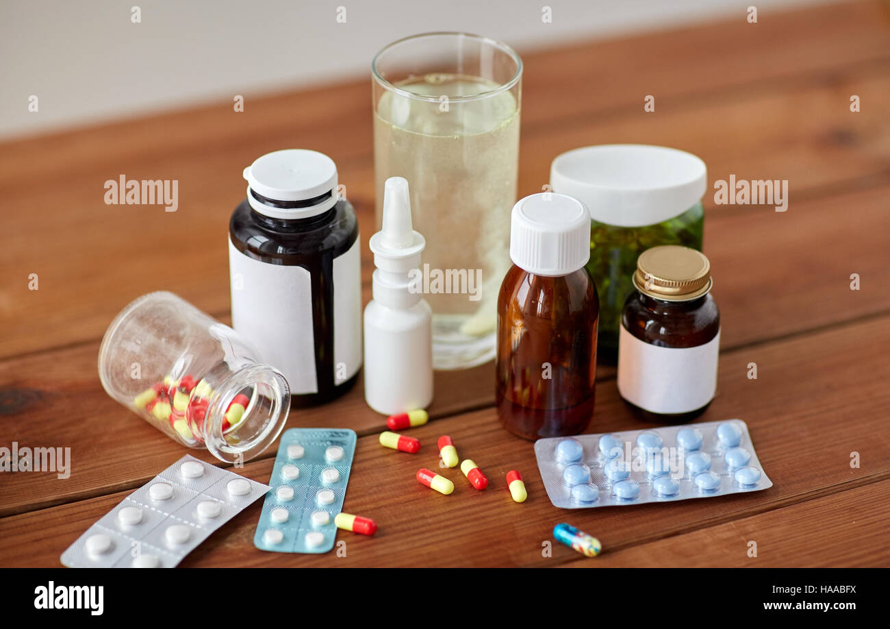 medicine and drugs on wooden table Stock Photo - Alamy