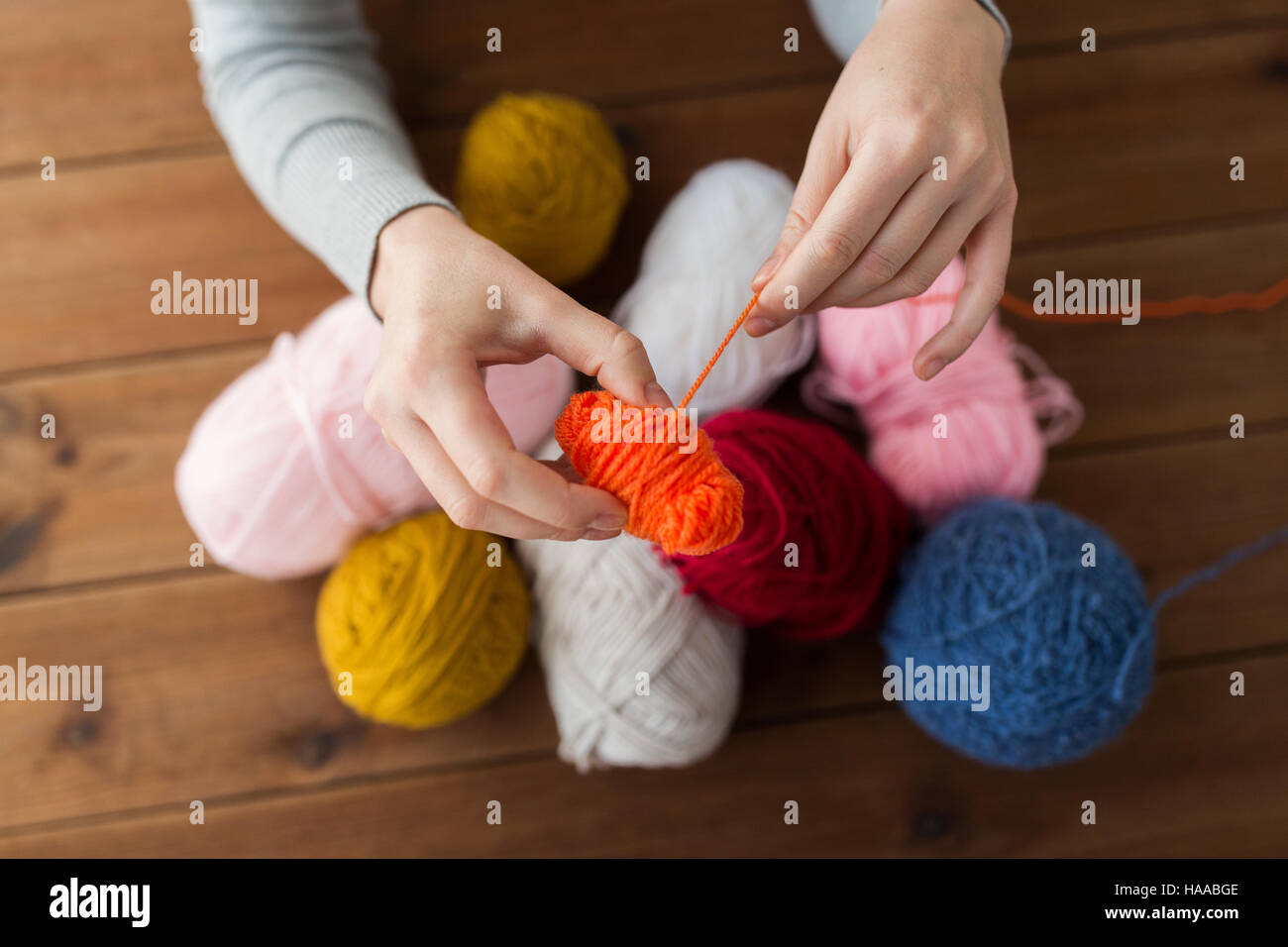 woman pulling yarn up into ball Stock Photo - Alamy