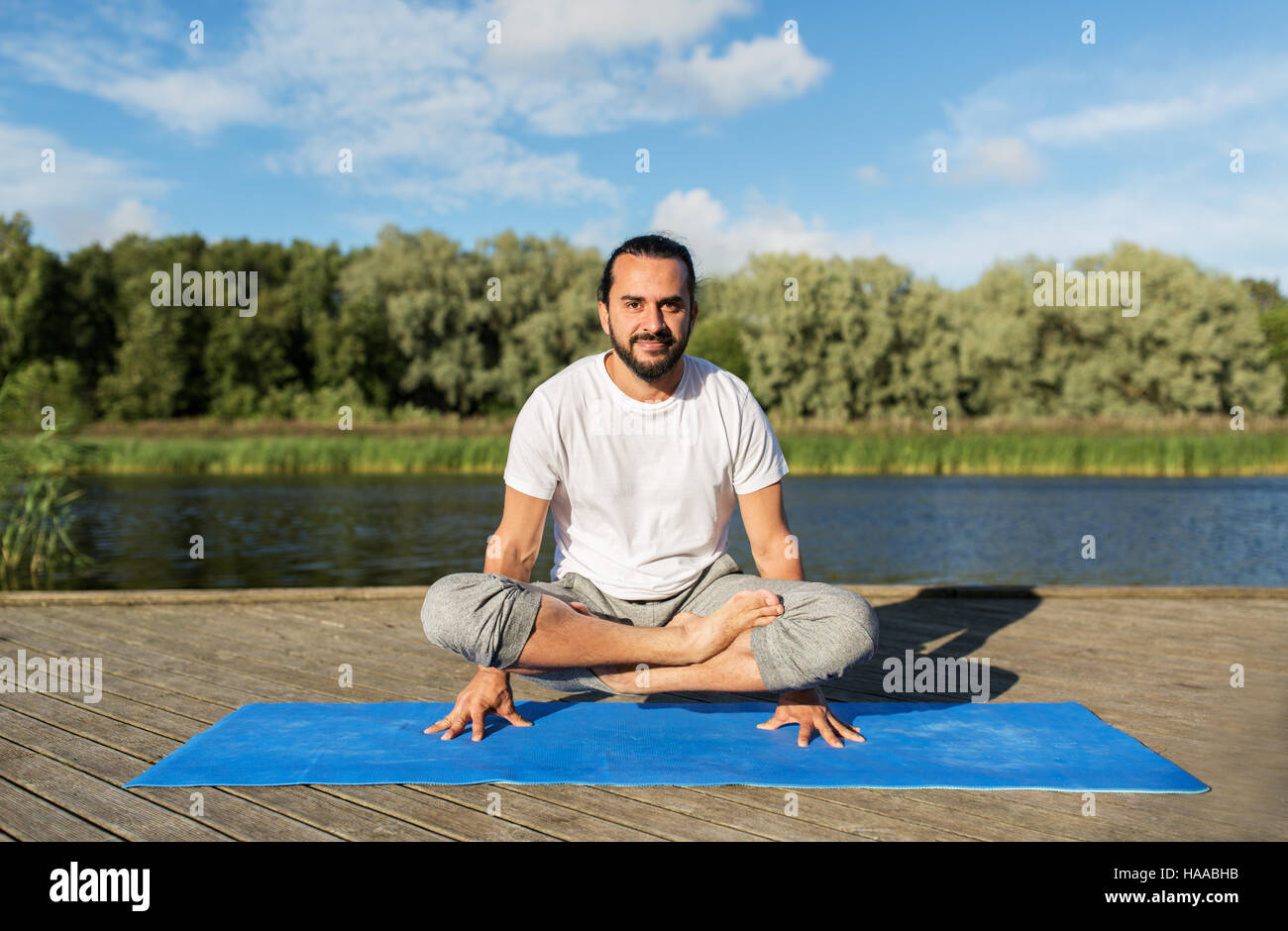 man making yoga in scale pose outdoors Stock Photo - Alamy