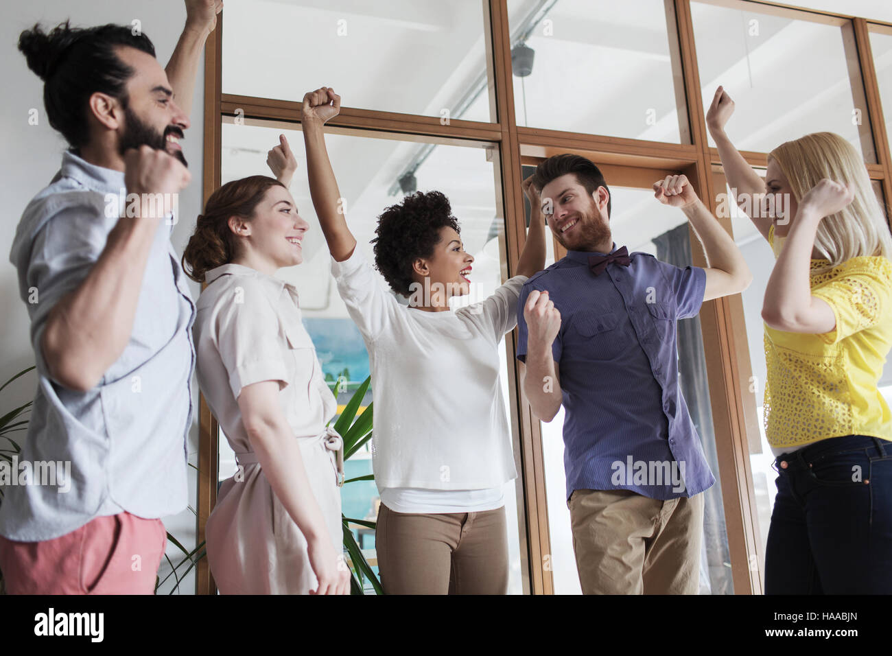 happy creative team celebrating victory in office Stock Photo - Alamy