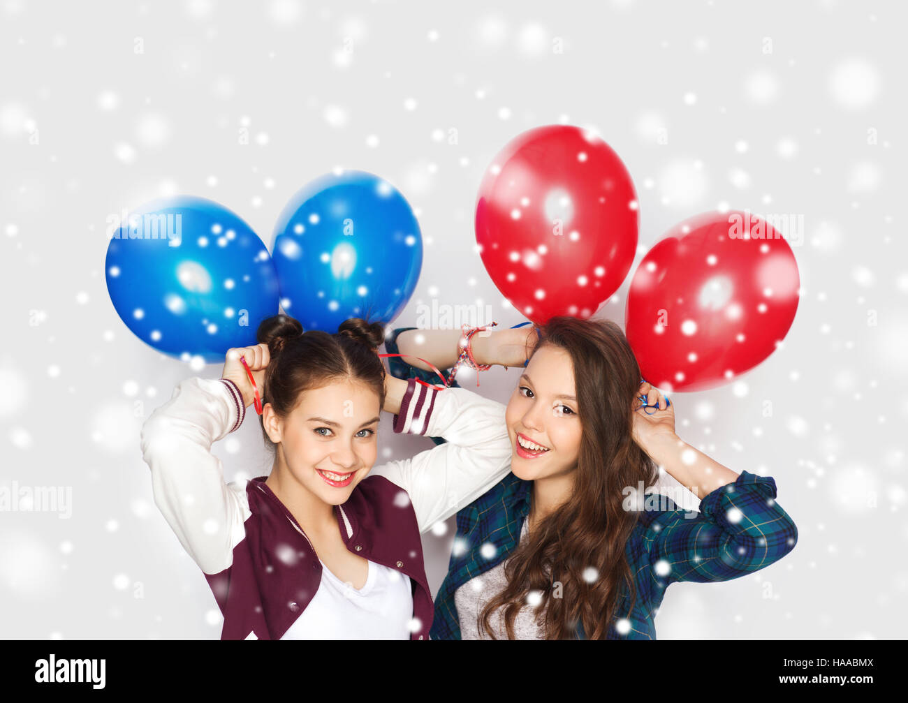 happy teenage girls with helium balloons over snow Stock Photo - Alamy