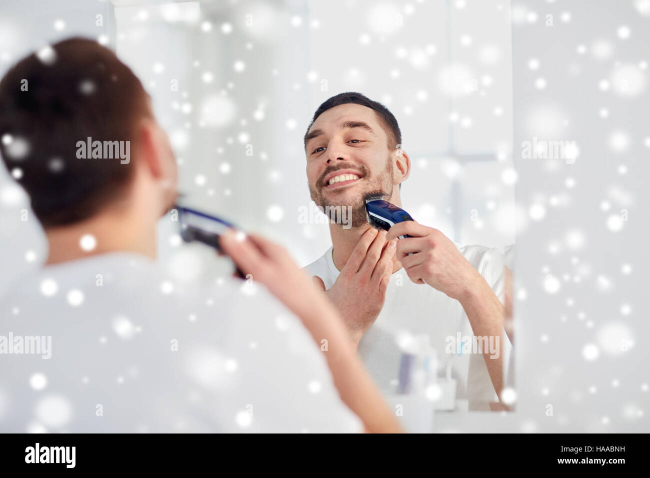 man shaving beard with trimmer at bathroom Stock Photo - Alamy