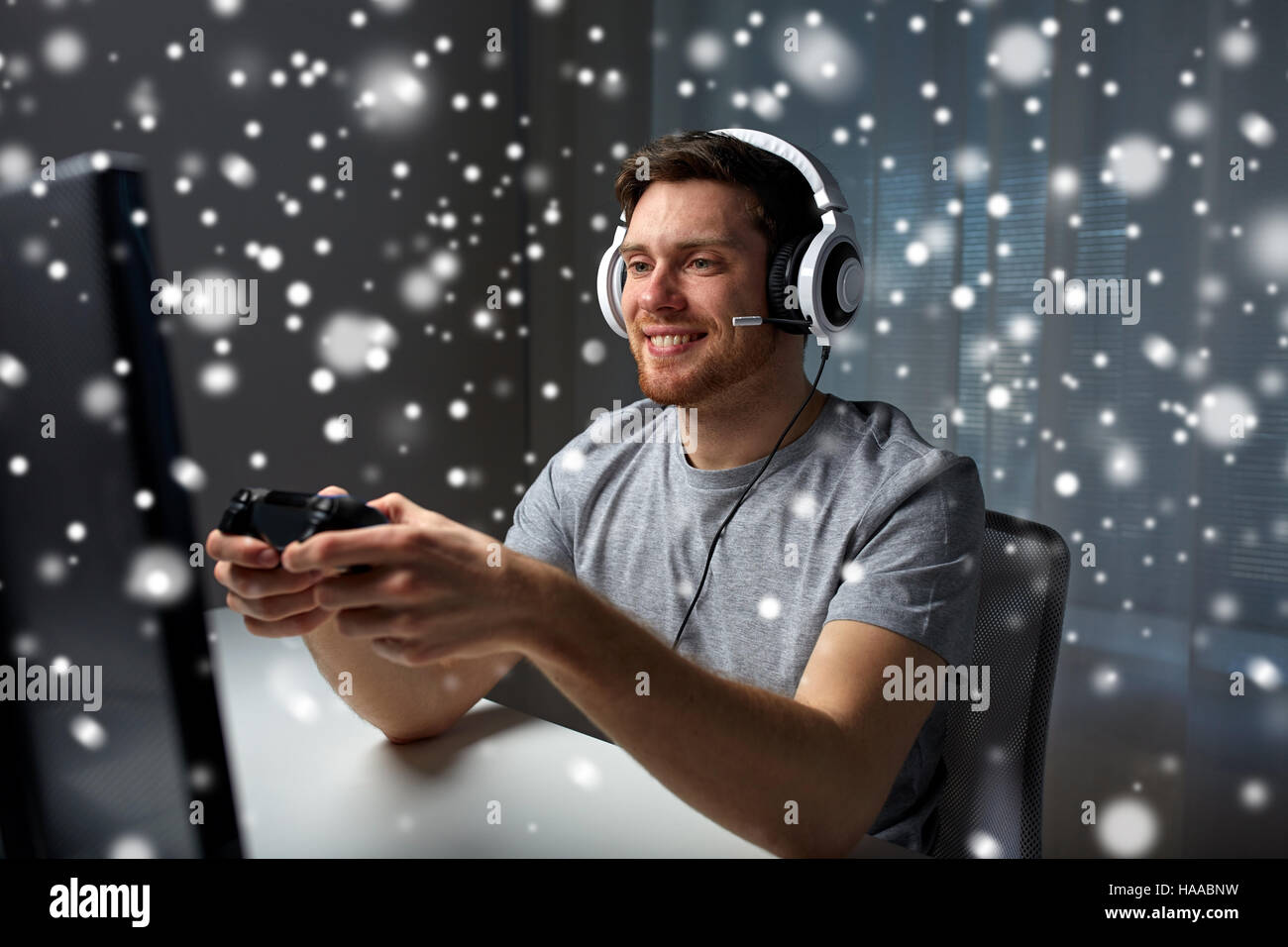 man in headset playing computer video game at home Stock Photo - Alamy