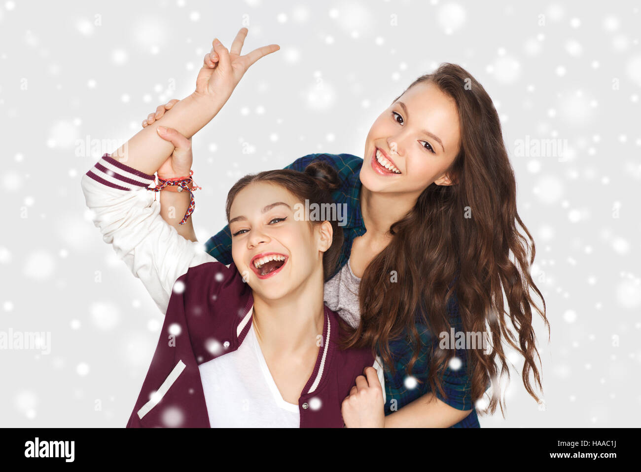 happy pretty teenage girls showing peace hand sign Stock Photo - Alamy