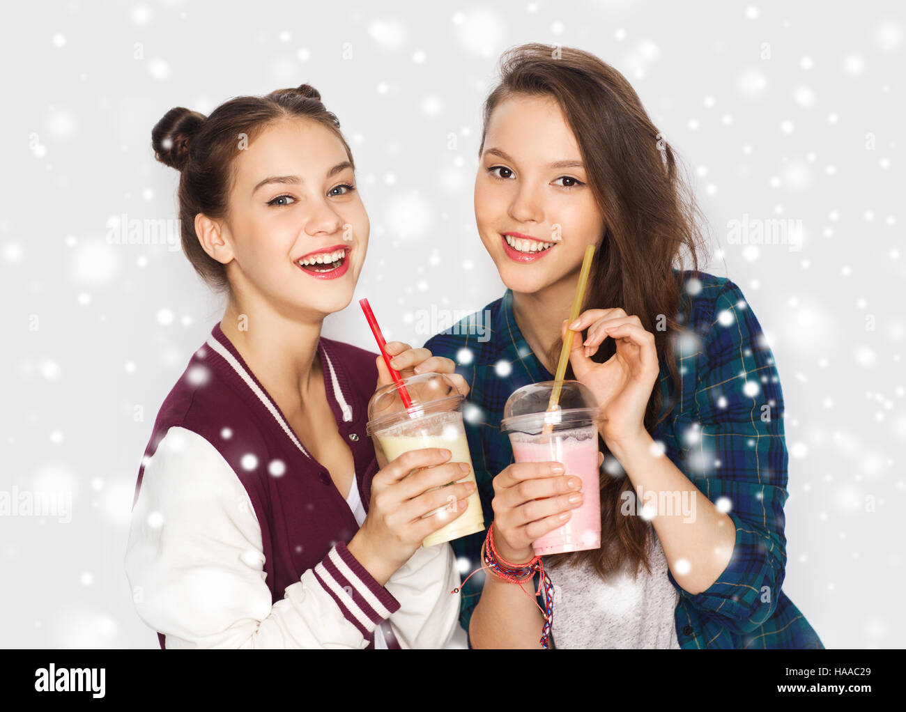happy pretty teenage girls drinking milk shakes Stock Photo - Alamy