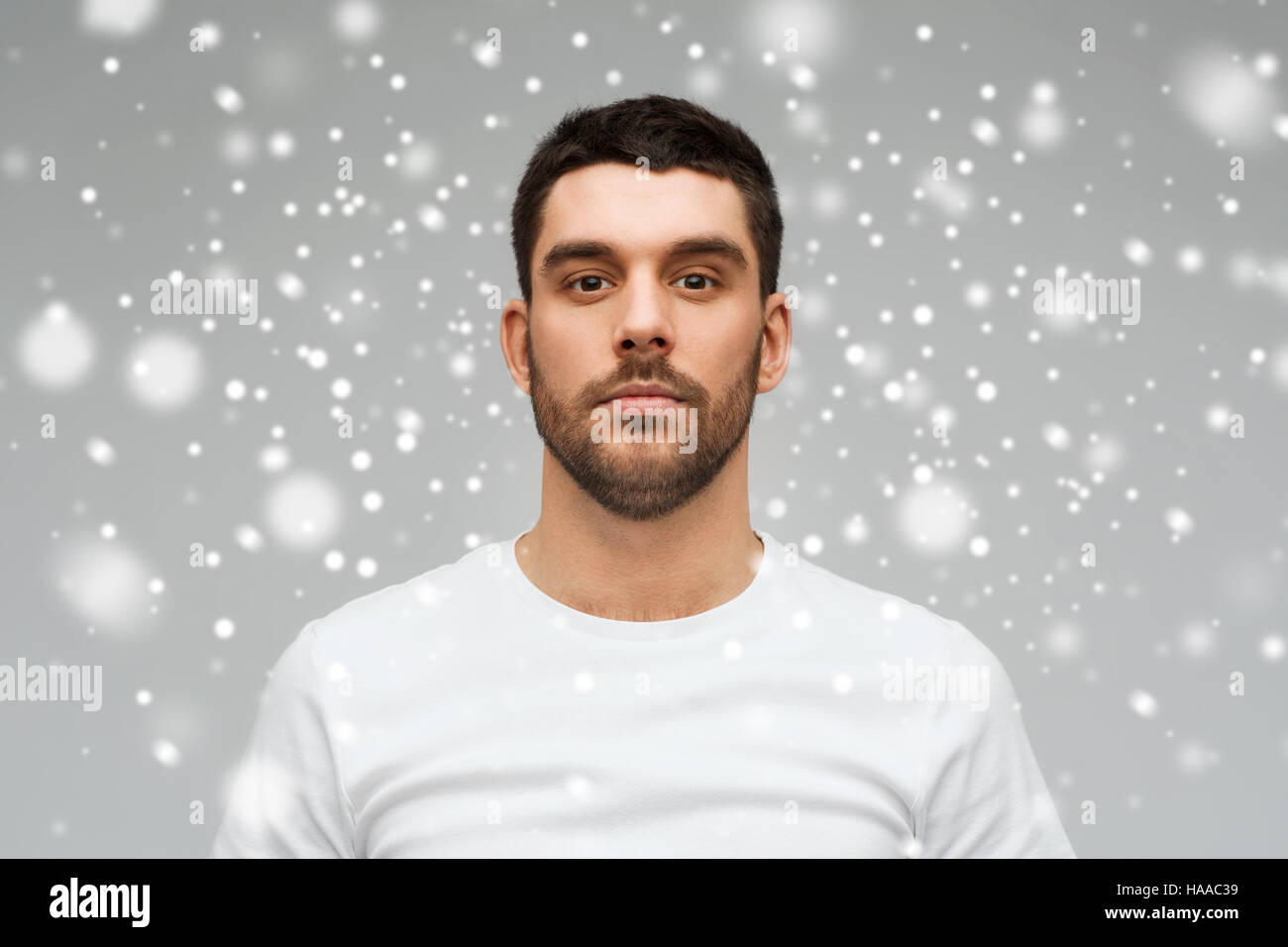 young man portrait over snow background Stock Photo - Alamy