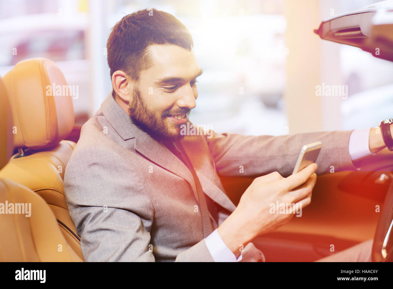 happy man sitting in car at auto show or salon Stock Photo - Alamy