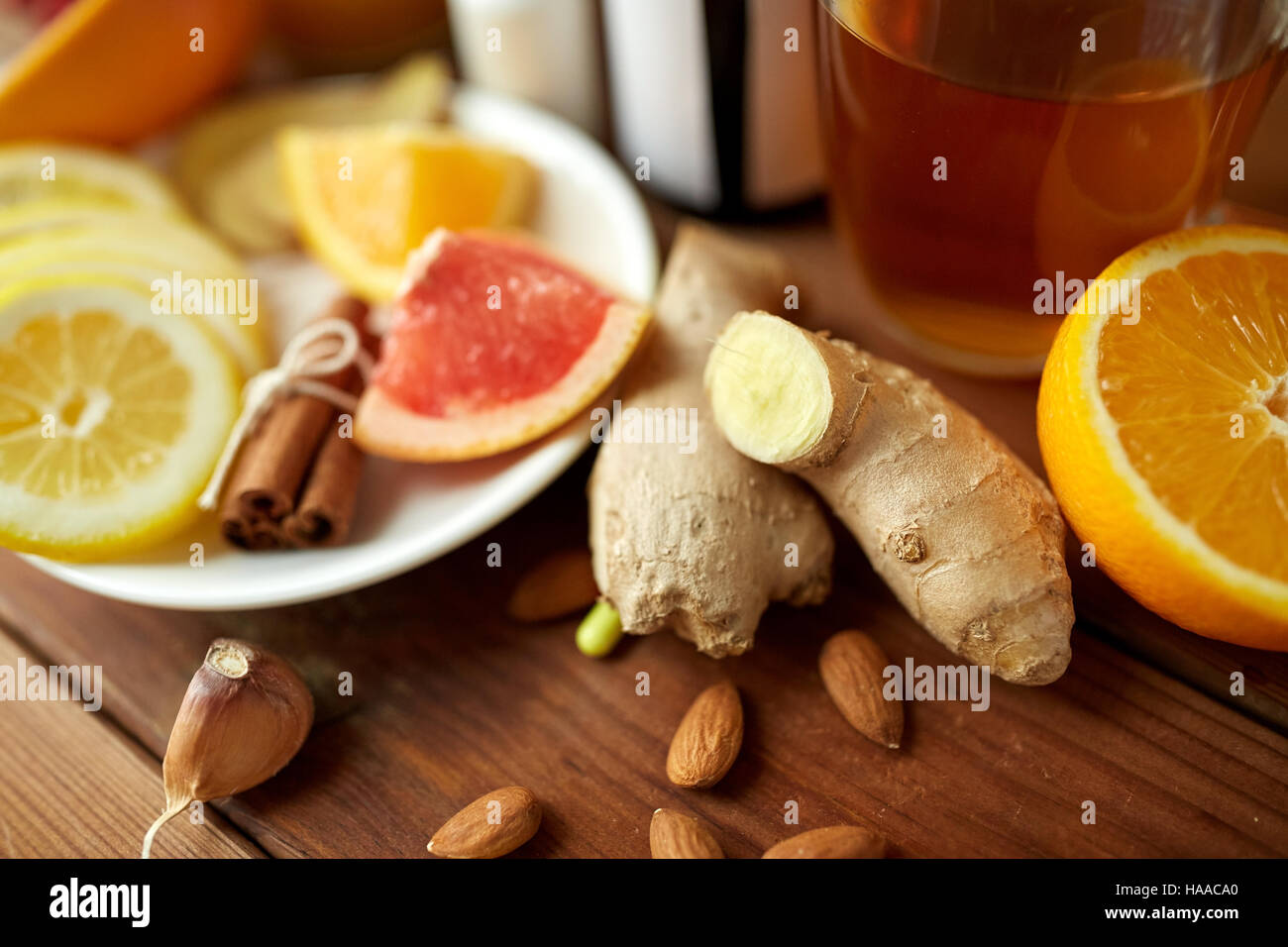 ginger, citrus fruits, tea or honey on wood Stock Photo - Alamy