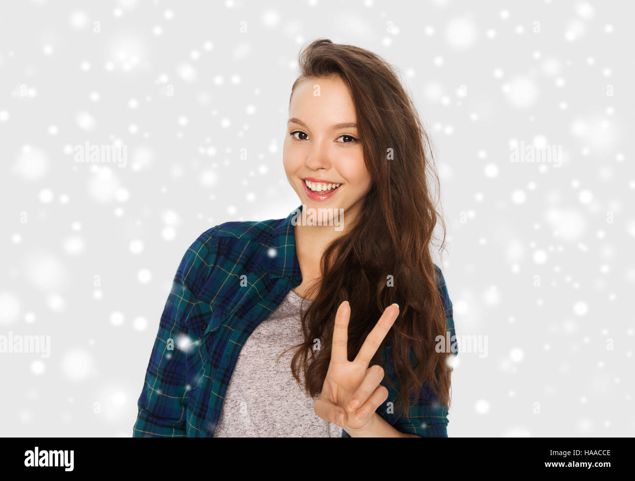 happy smiling teenage girl showing peace sign Stock Photo - Alamy