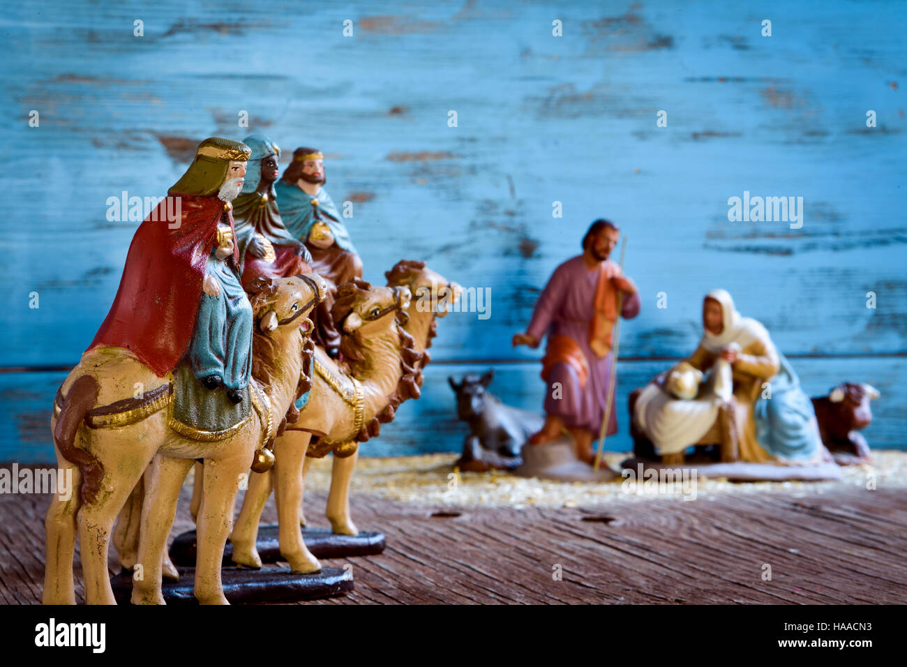 the three kings on their camels and the holy family in a rustic ...