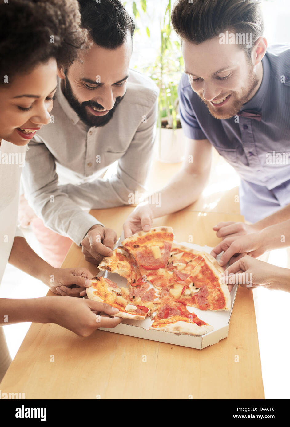 happy business team eating pizza in office Stock Photo - Alamy