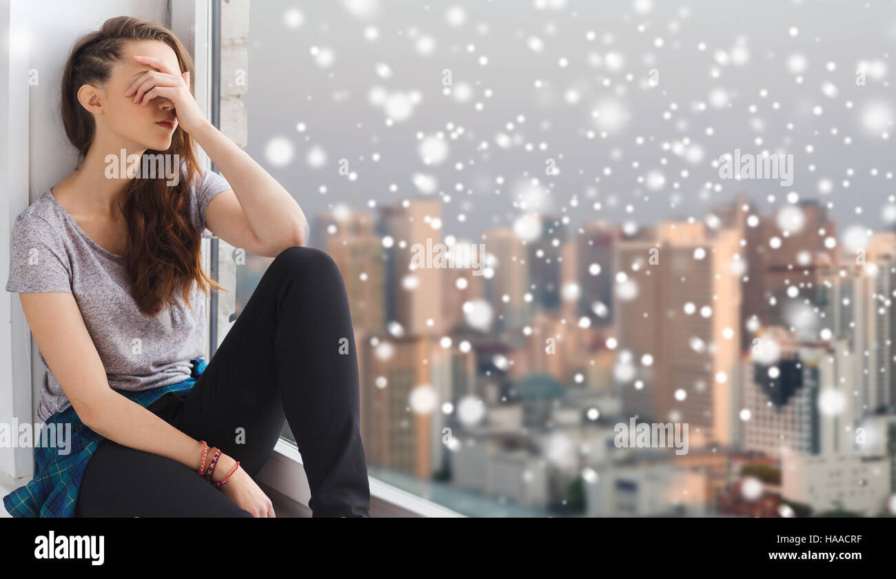 sad pretty teenage girl sitting at window Stock Photo - Alamy