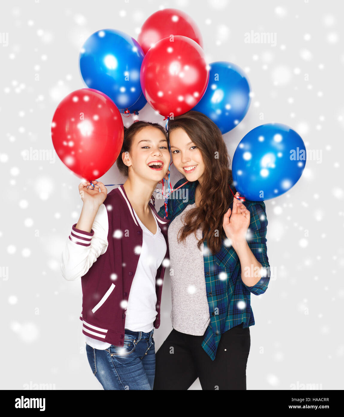 happy teenage girls with helium balloons over snow Stock Photo - Alamy