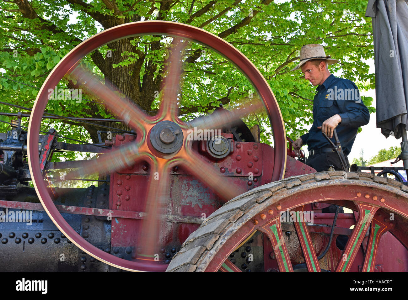 steam traction engine with young operator maintaining the machinery at ...
