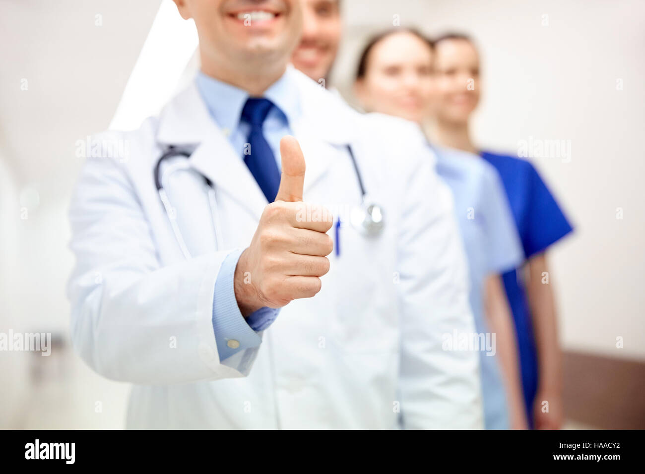 close up of doctors at hospital showing thumbs Stock Photo - Alamy