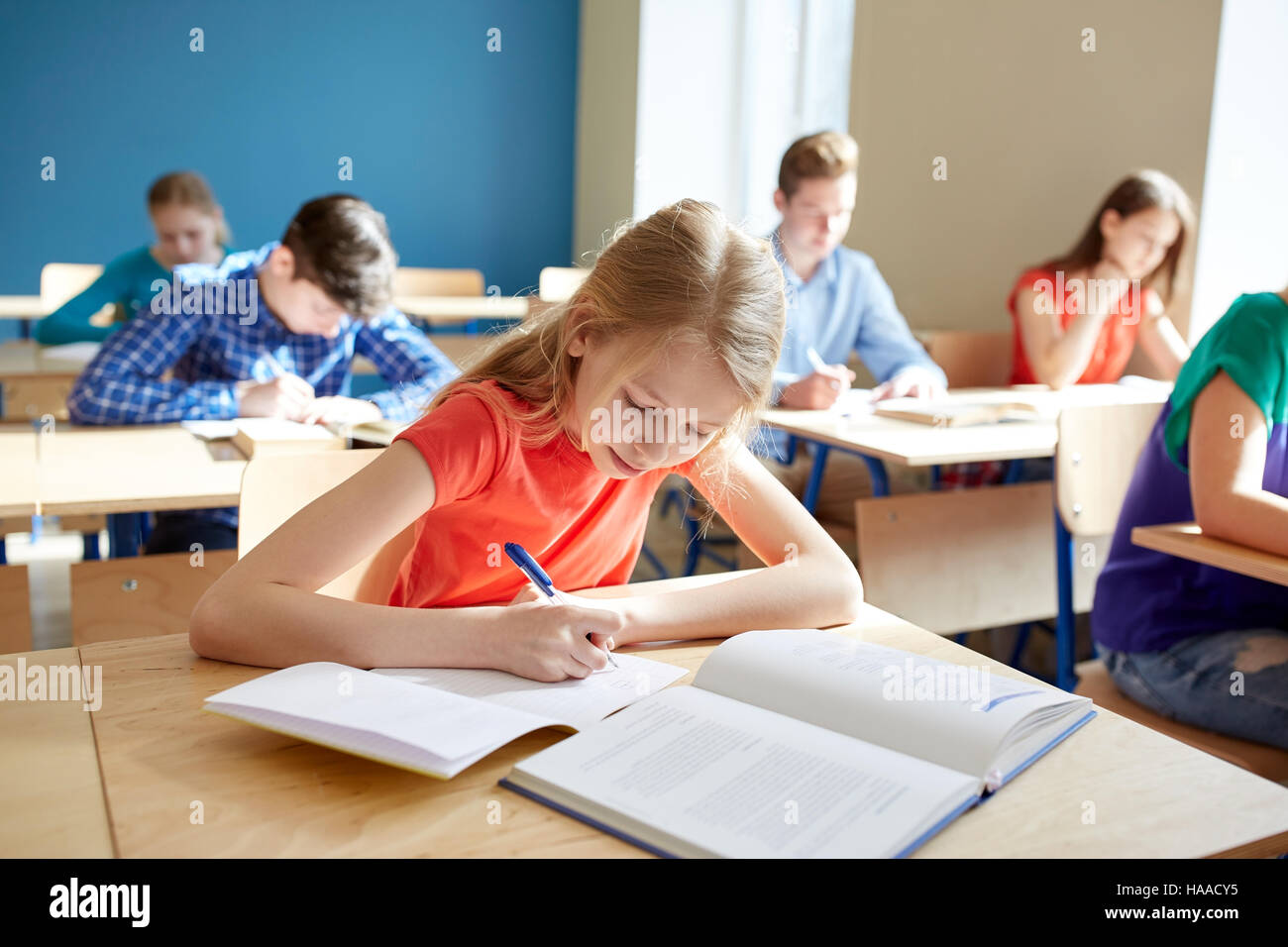 student girl with book writing school test Stock Photo - Alamy