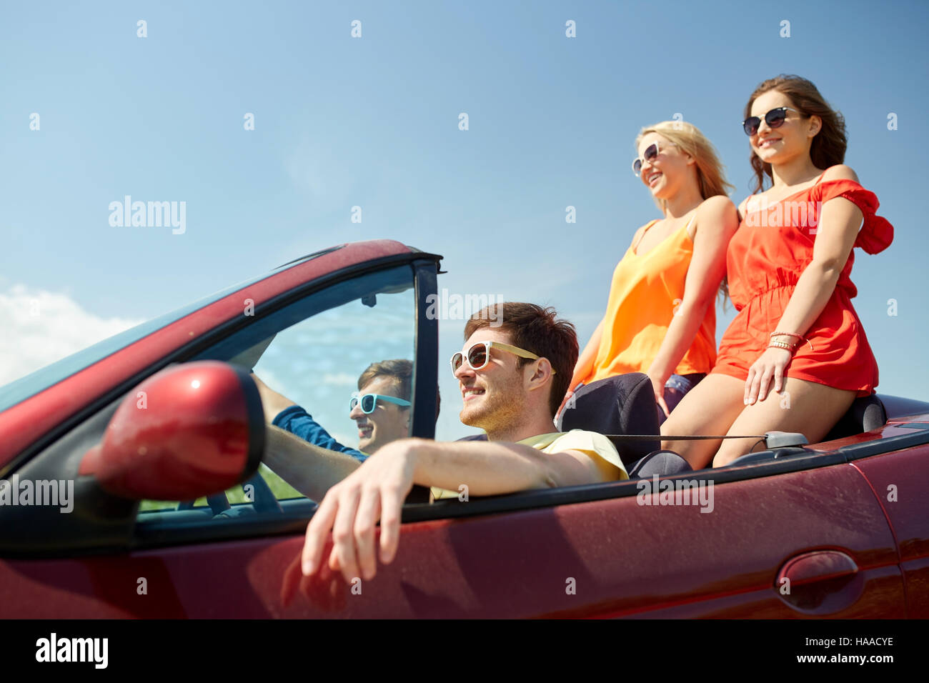happy friends driving in cabriolet car Stock Photo - Alamy