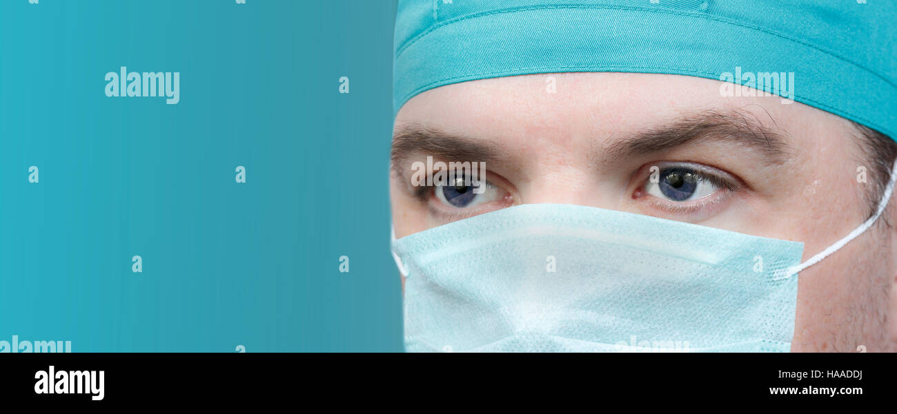 Close up of a male doctor face and eyes on even medical background ...