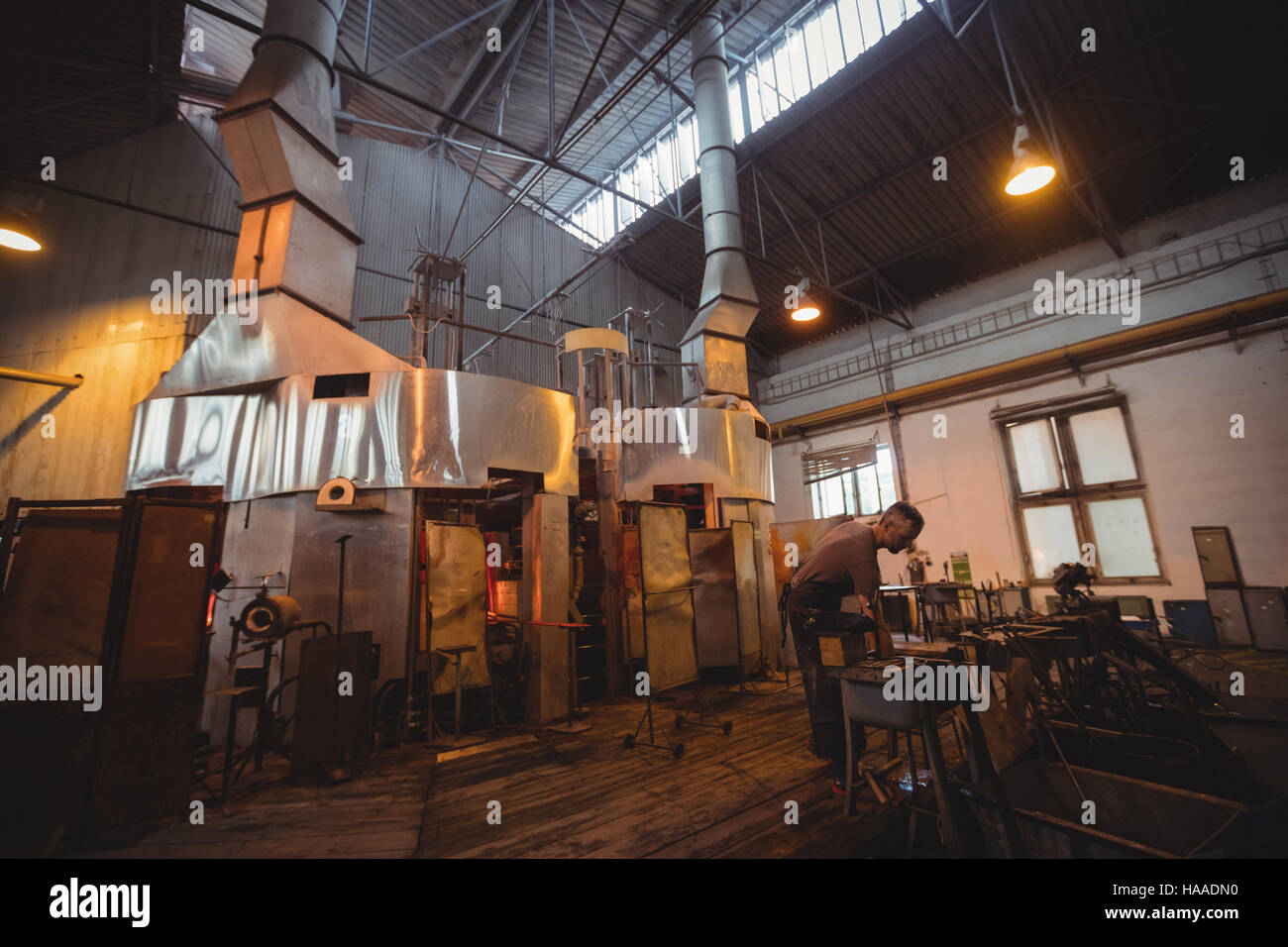 Glassblower working on marver table Stock Photo - Alamy