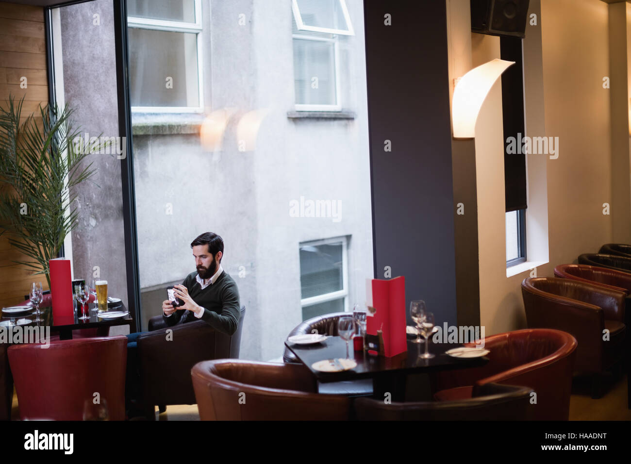 Man using mobile phone in bar Stock Photo - Alamy