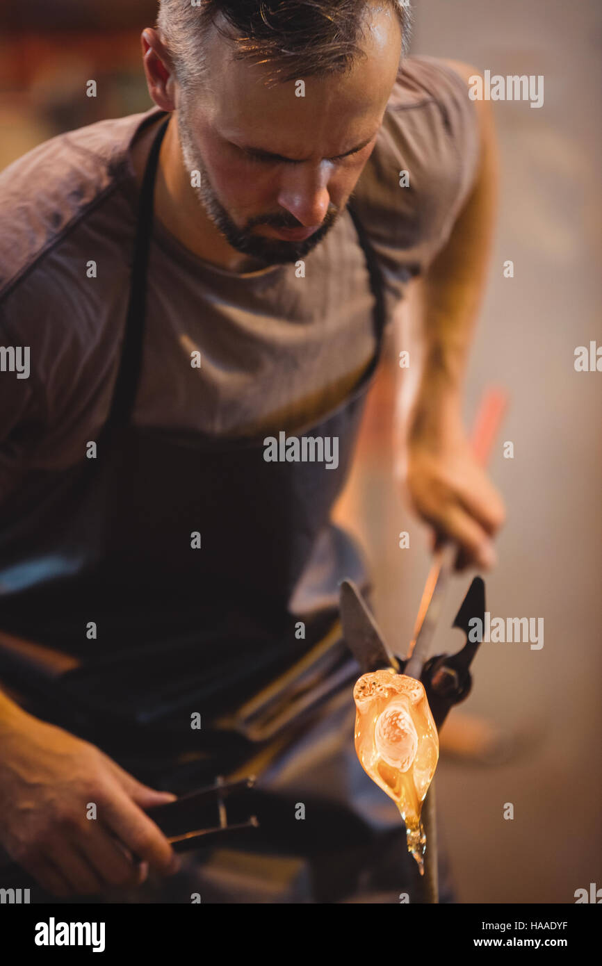 Glassblower shaping a molten glass Stock Photo - Alamy