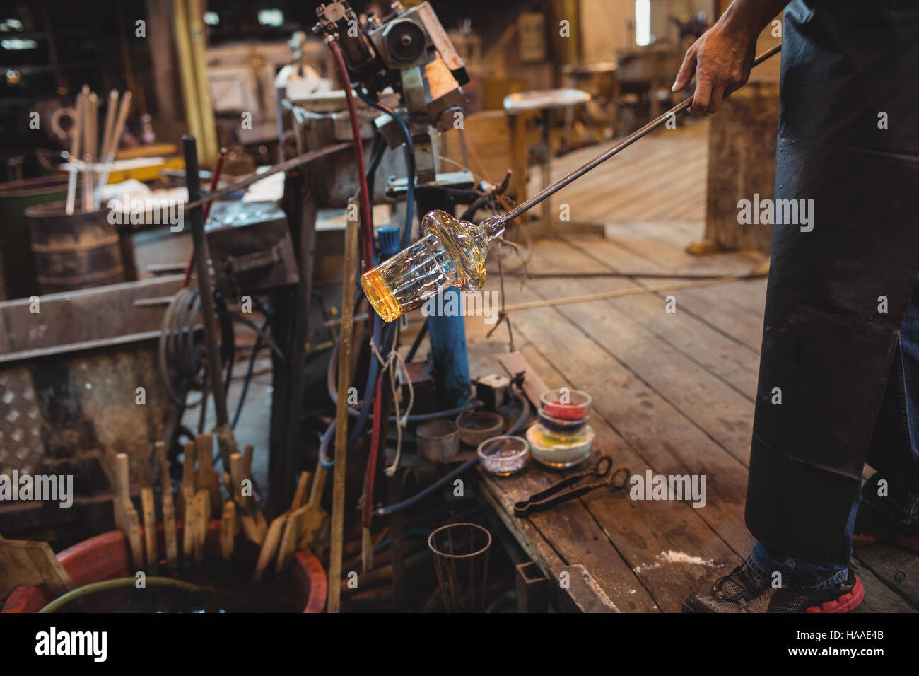 Glassblower shaping a molten glass Stock Photo - Alamy